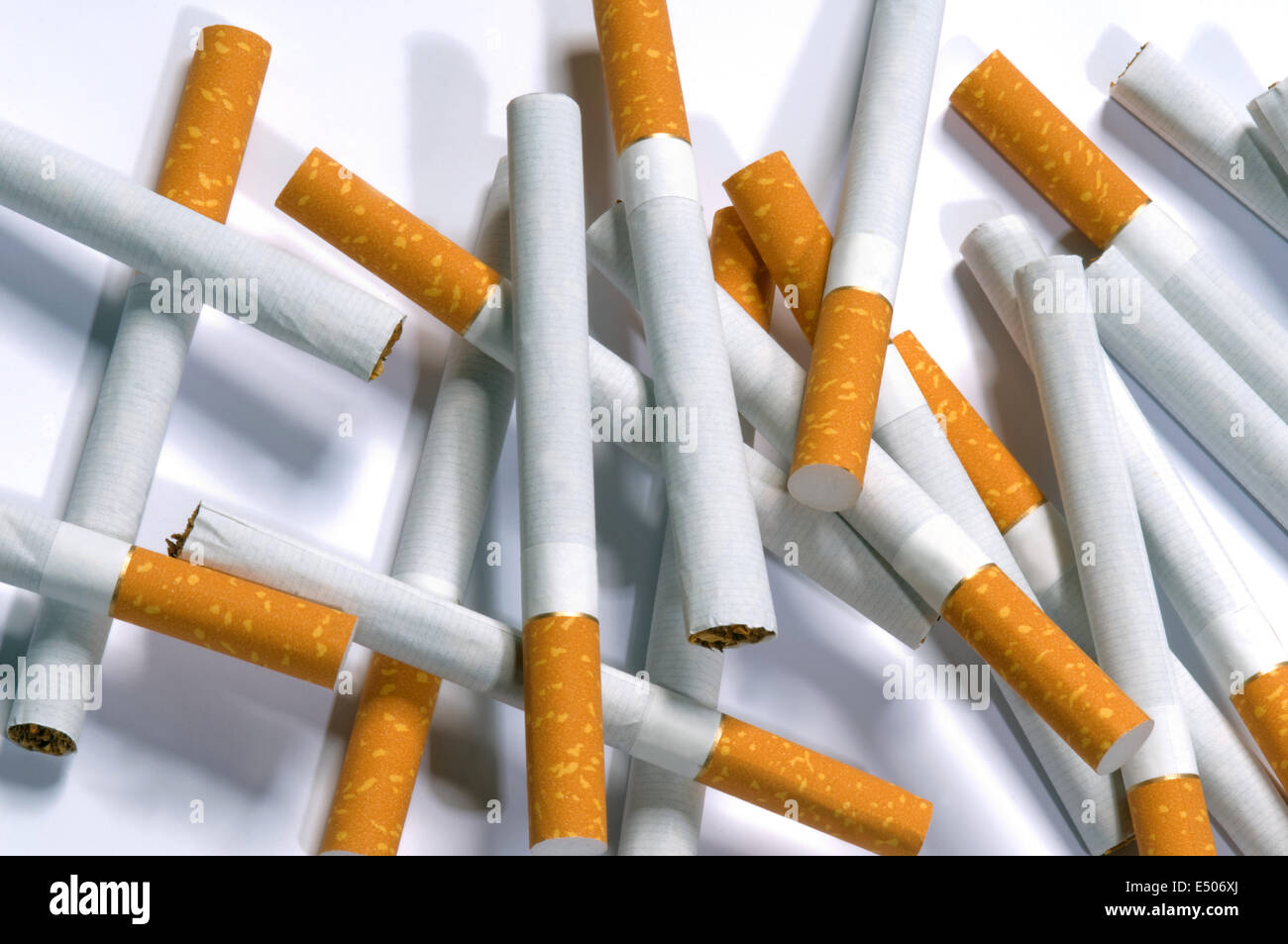cigarettes lying on a white background Stock Photo - Alamy