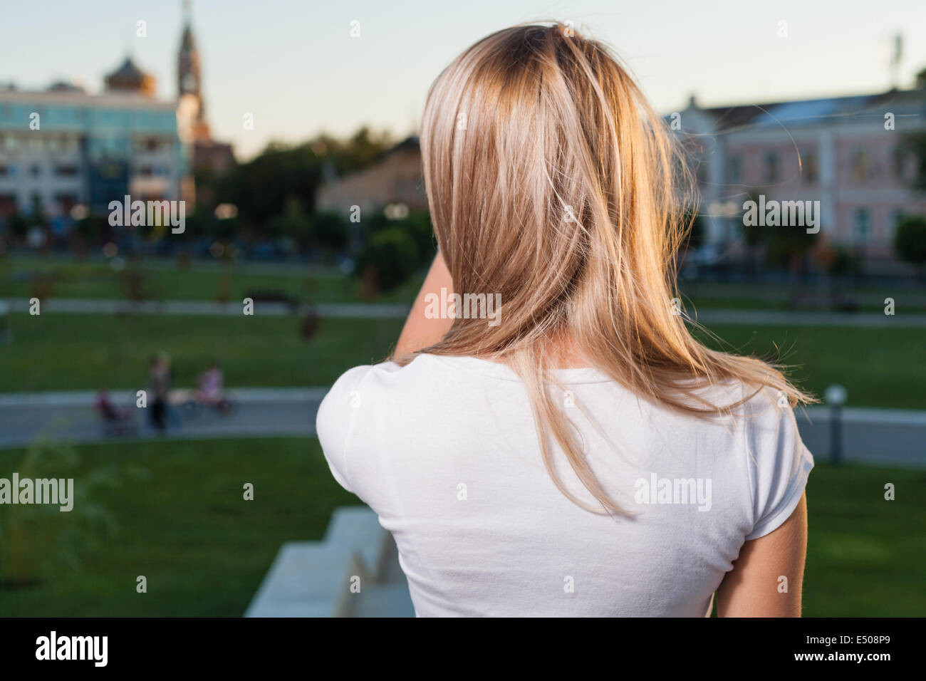 Blonde girl standing back hi-res stock photography and images - Alamy