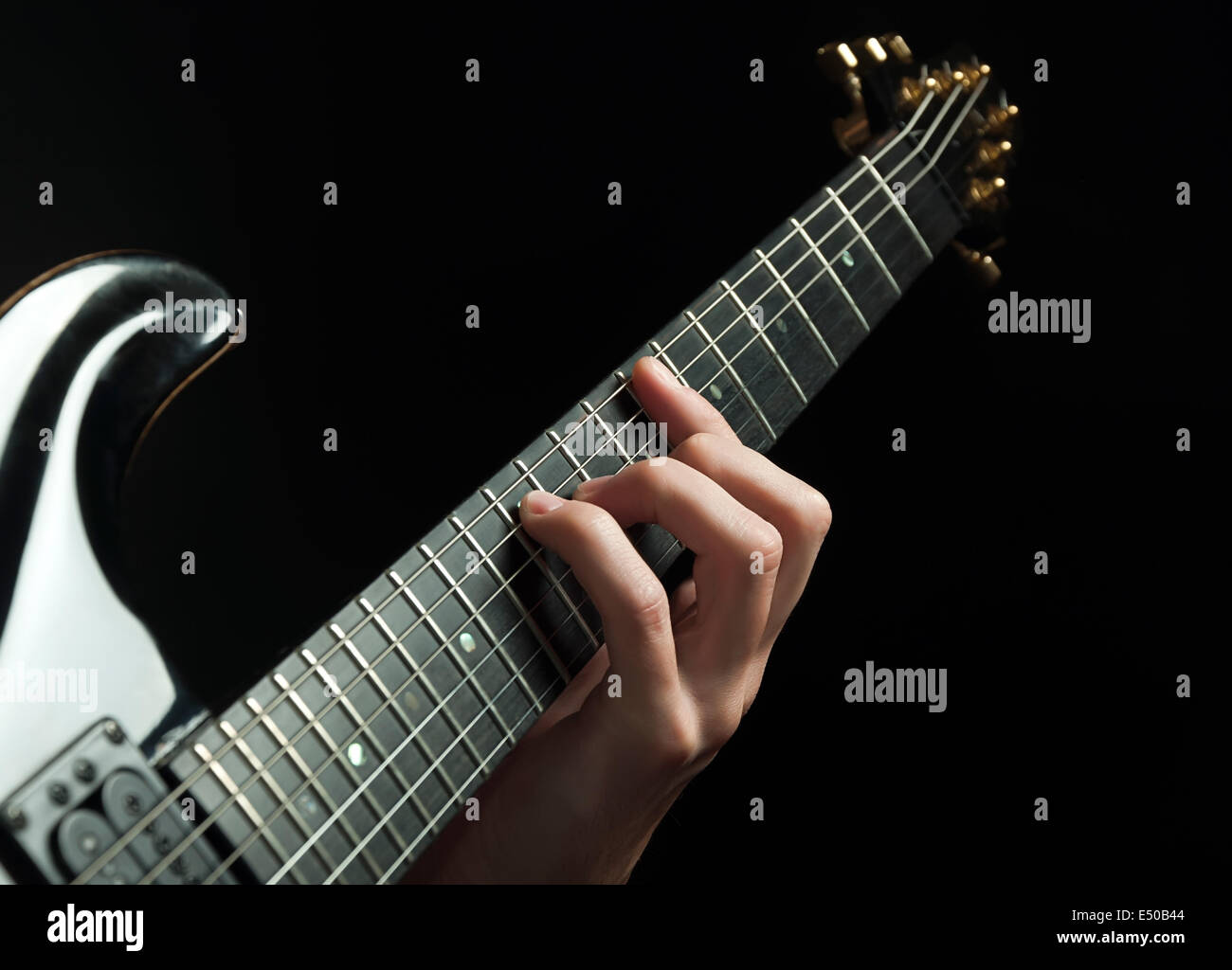guitarist hand playing guitar over black Stock Photo - Alamy