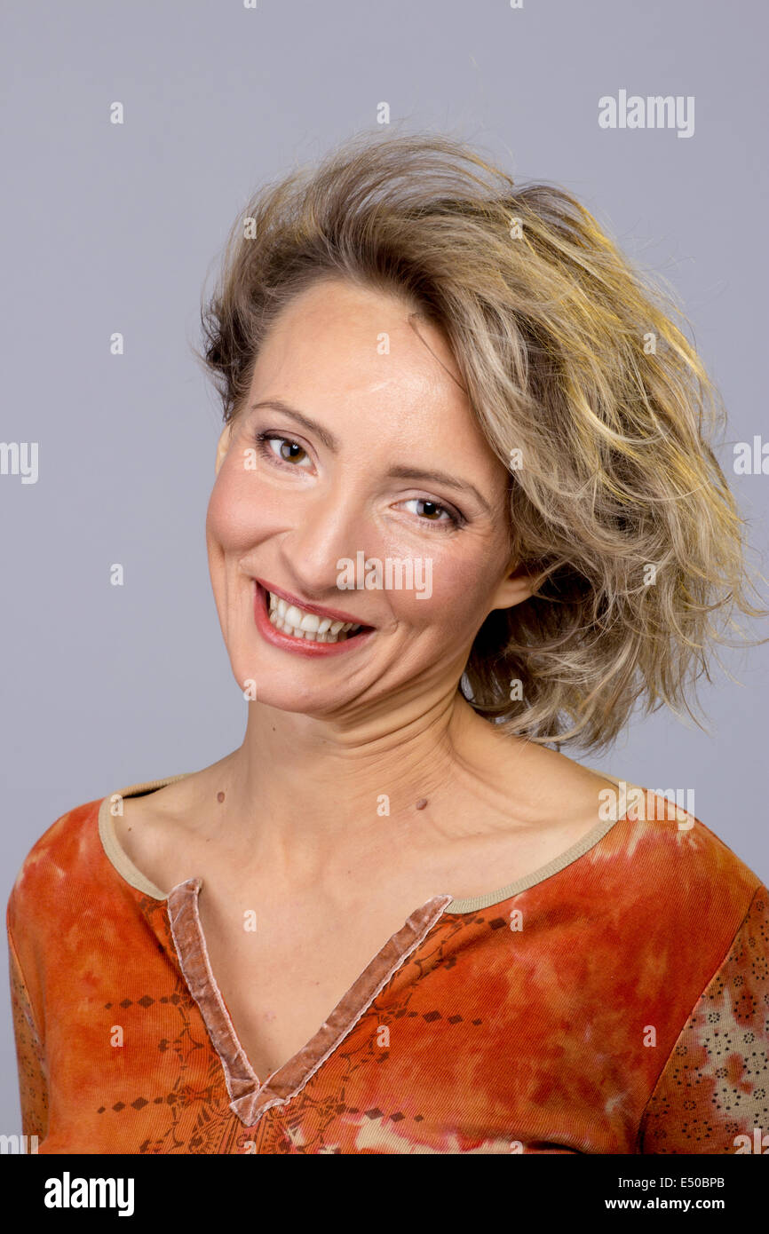 Beautiful mid age woman on grey backgraund Stock Photo - Alamy