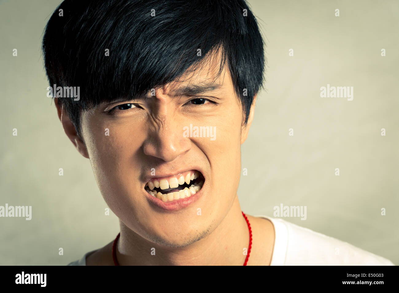 Young man looking angry Stock Photo - Alamy