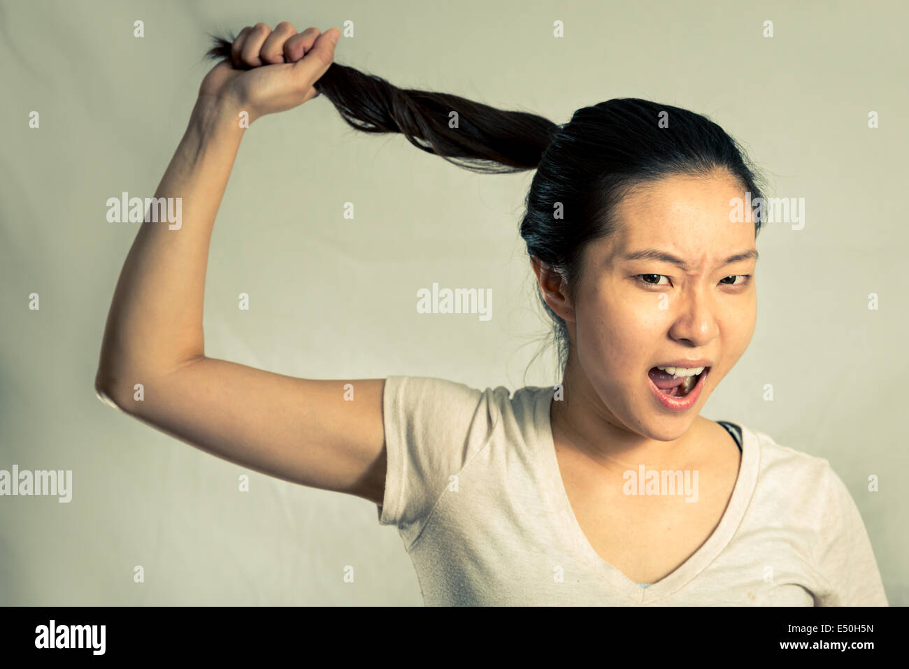 Angry woman pulling hair hi-res stock photography and images - Alamy