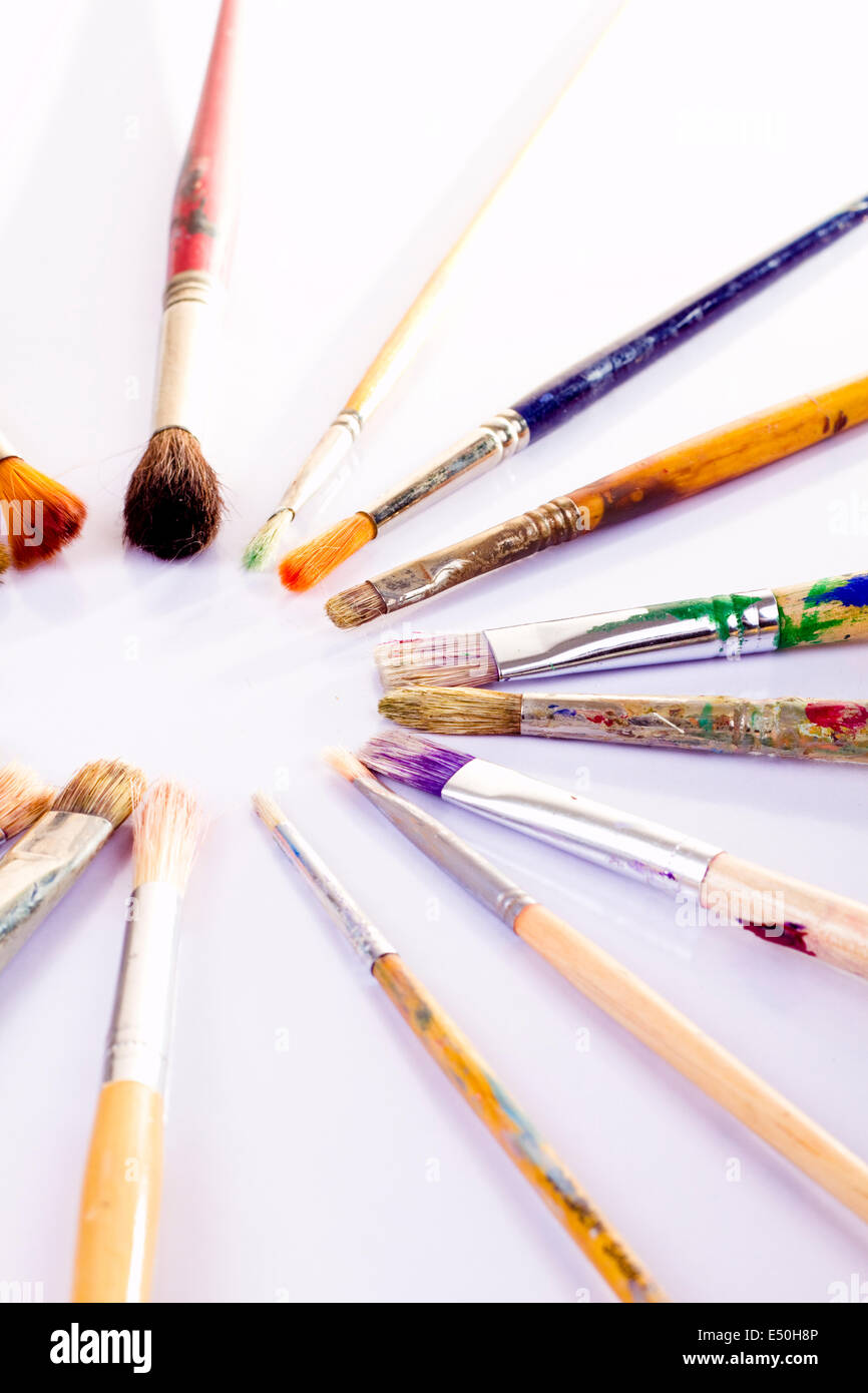 Used paint brushes of different colors Stock Photo - Alamy