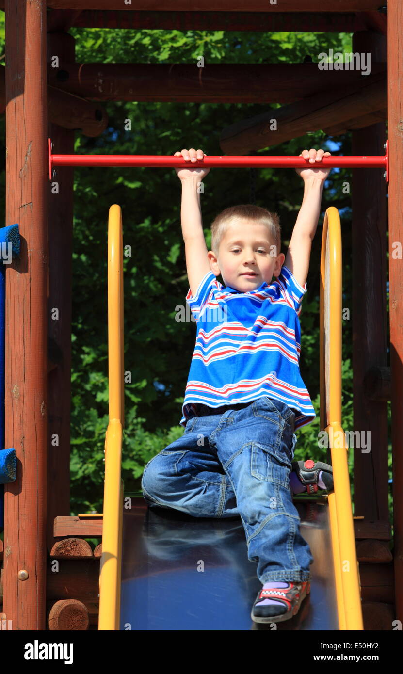child in playground, kid in action playing Stock Photo - Alamy
