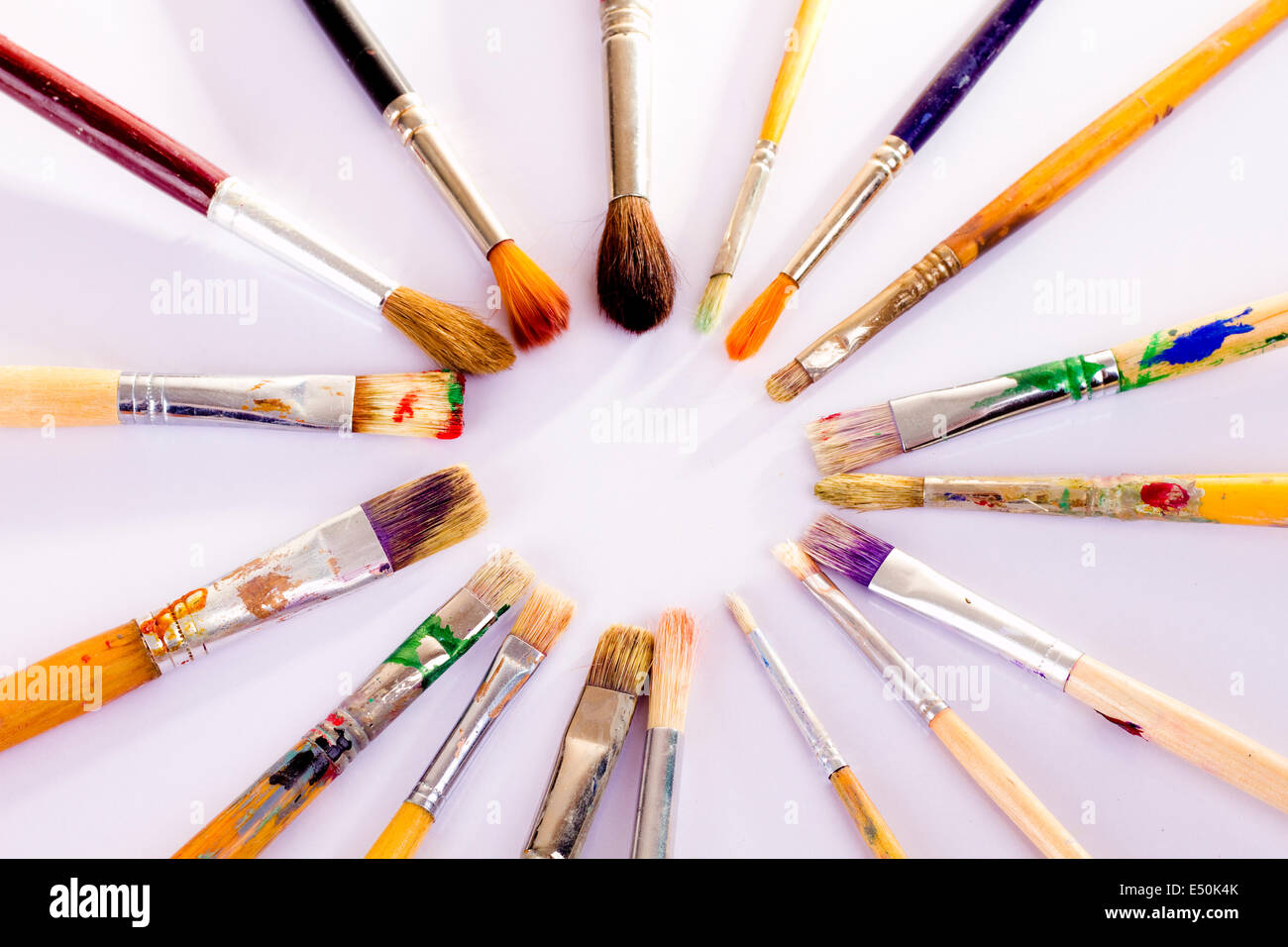 Used paint brushes of different colors Stock Photo - Alamy