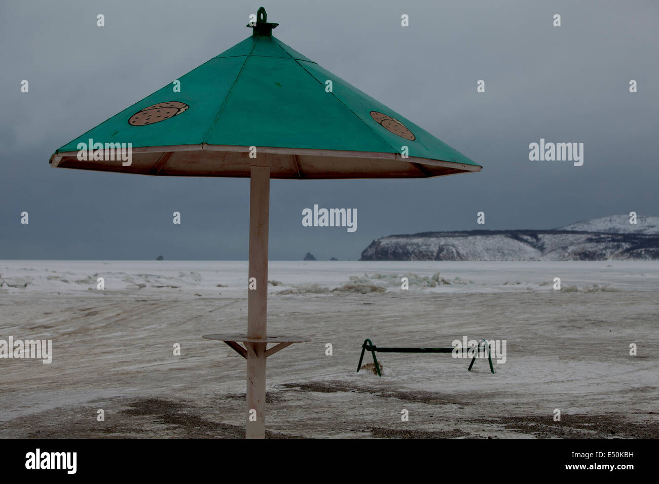 Snowy deserted beach parasol bench Russia Stock Photo - Alamy