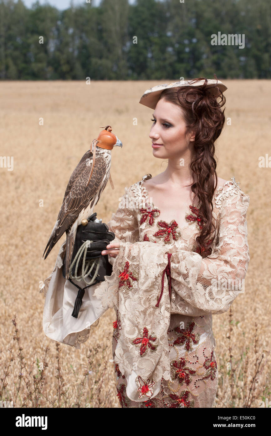Woman with hawk on hand Stock Photo - Alamy