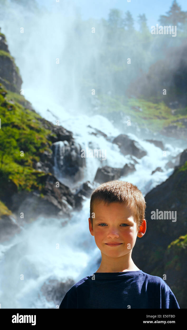 Portrait boy on summer waterfall background Stock Photo - Alamy