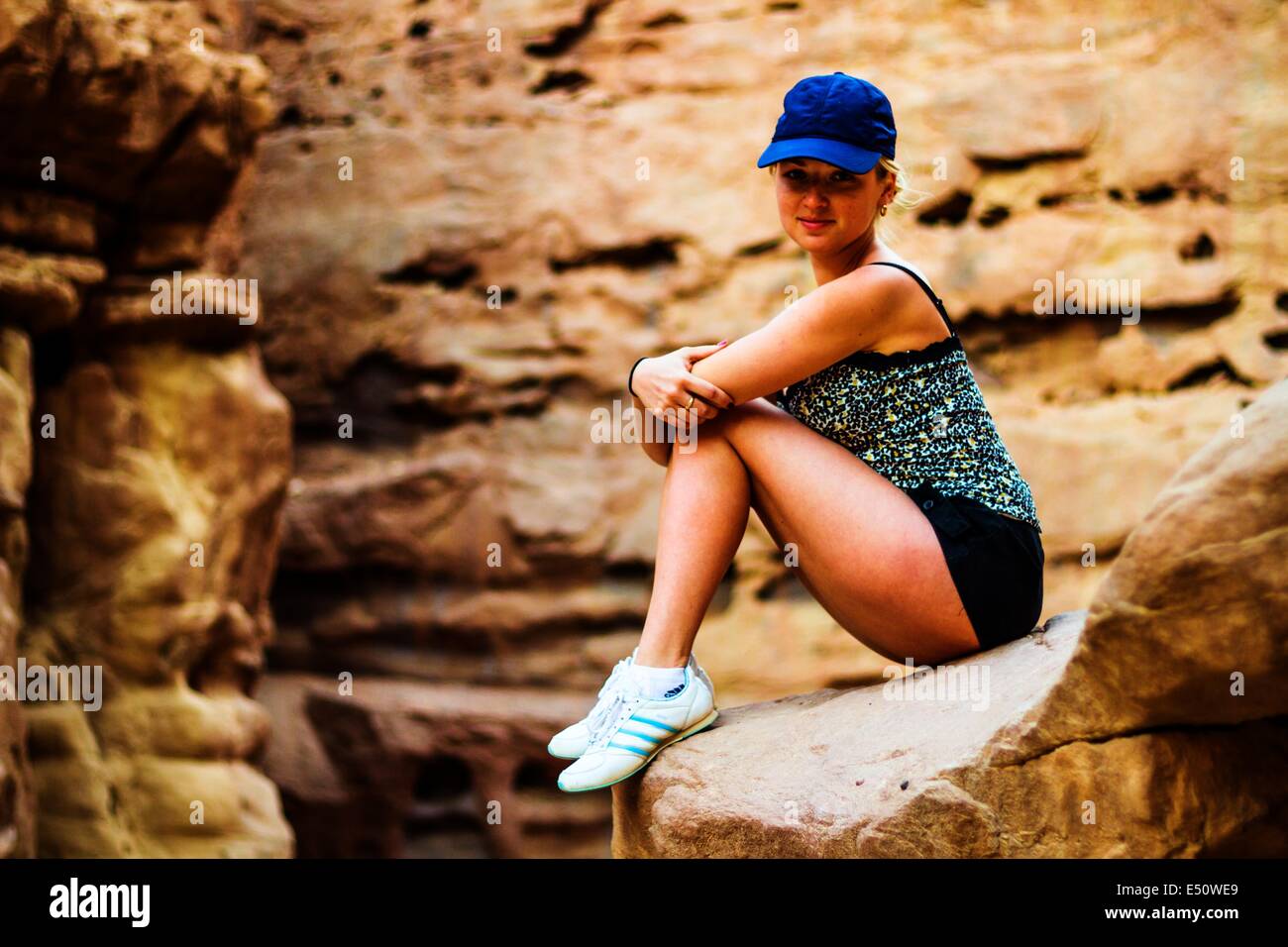 girl sitting on a rock Stock Photo - Alamy