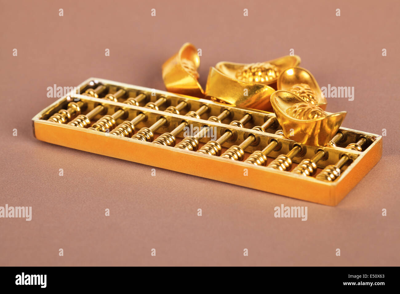 chinese gold ingot and golden abacus Stock Photo - Alamy