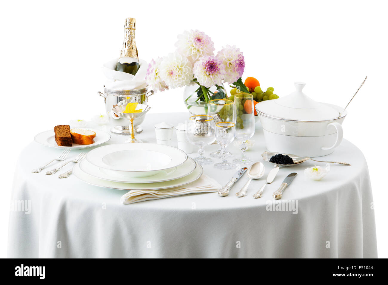 table with dishes and flowers Stock Photo - Alamy