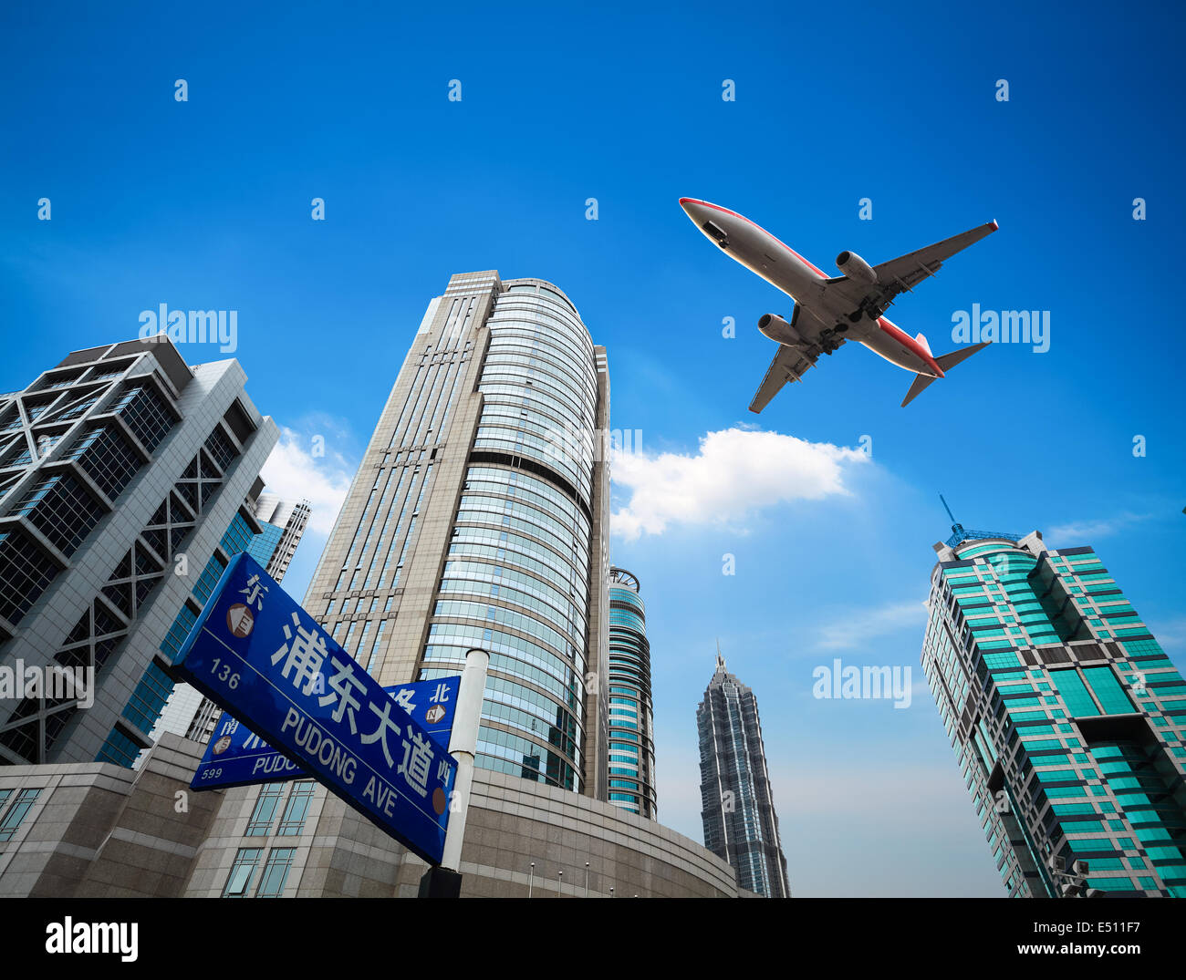upward view airplane with modern building Stock Photo - Alamy