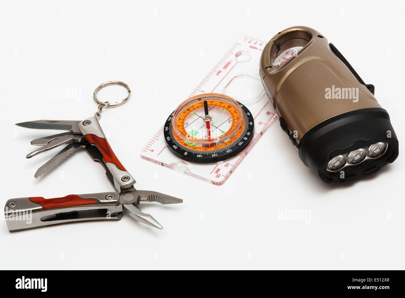 Knife, compass and an electric torch Stock Photo - Alamy