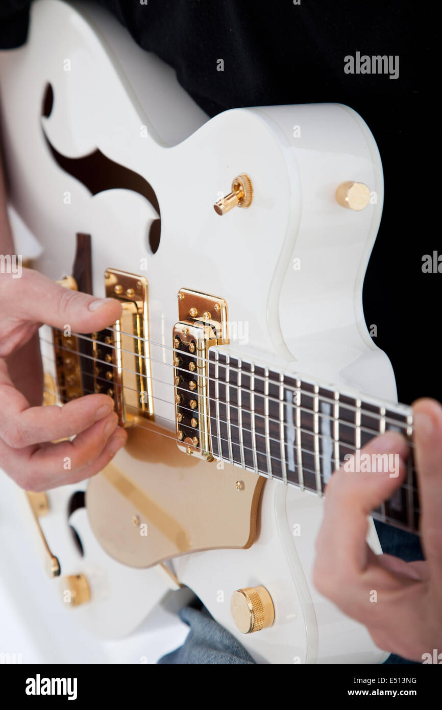 Hands of a man playing an electric guitar Stock Photo - Alamy