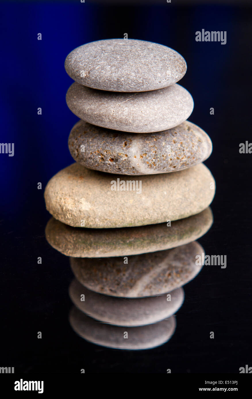 balanced stones with dark shadows Stock Photo - Alamy