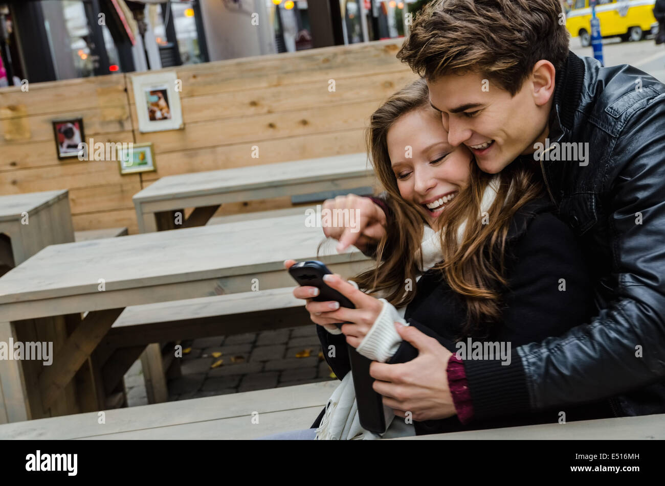 Happy young couple mobile hi-res stock photography and images - Alamy
