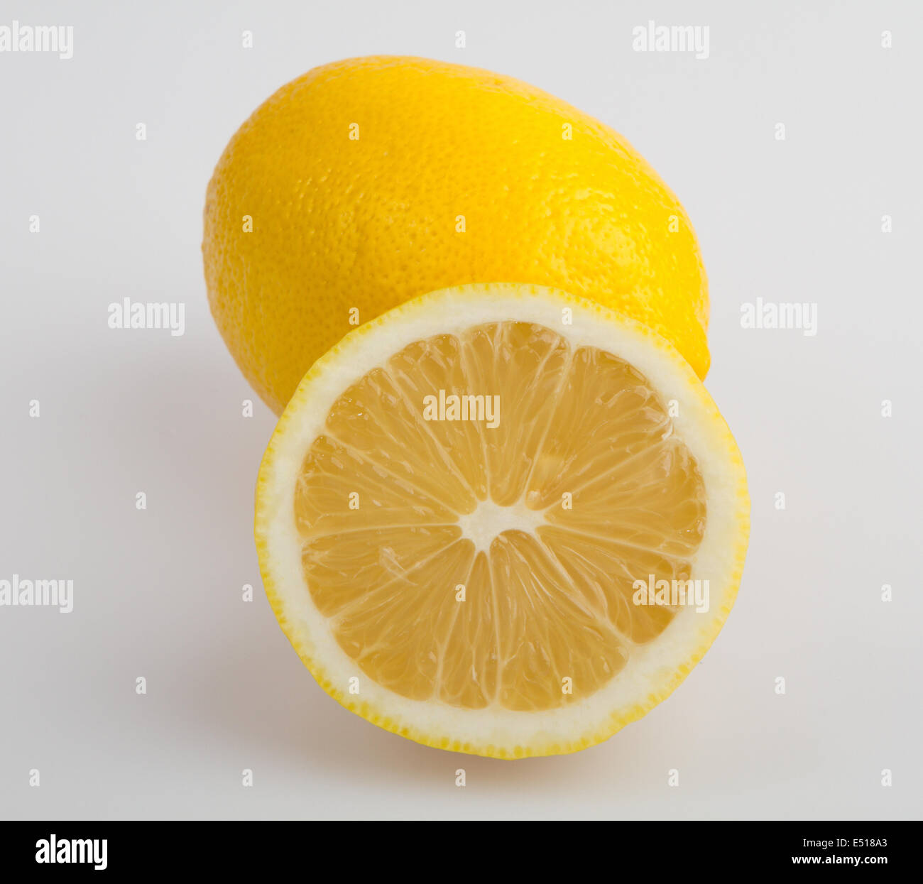 Full and cross section of yellow lemon Stock Photo - Alamy