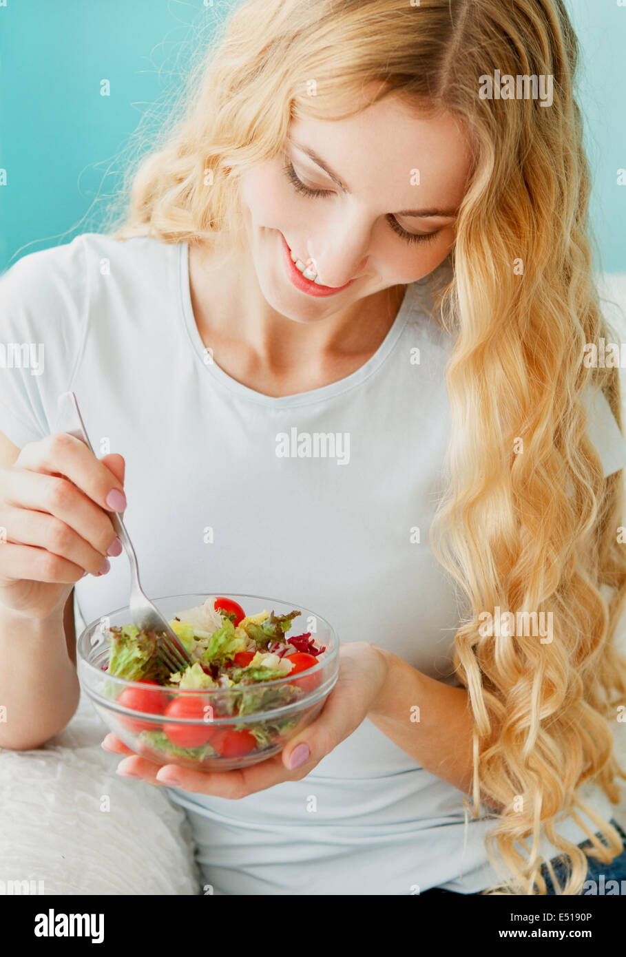 Female model eating green salad Stock Photo - Alamy