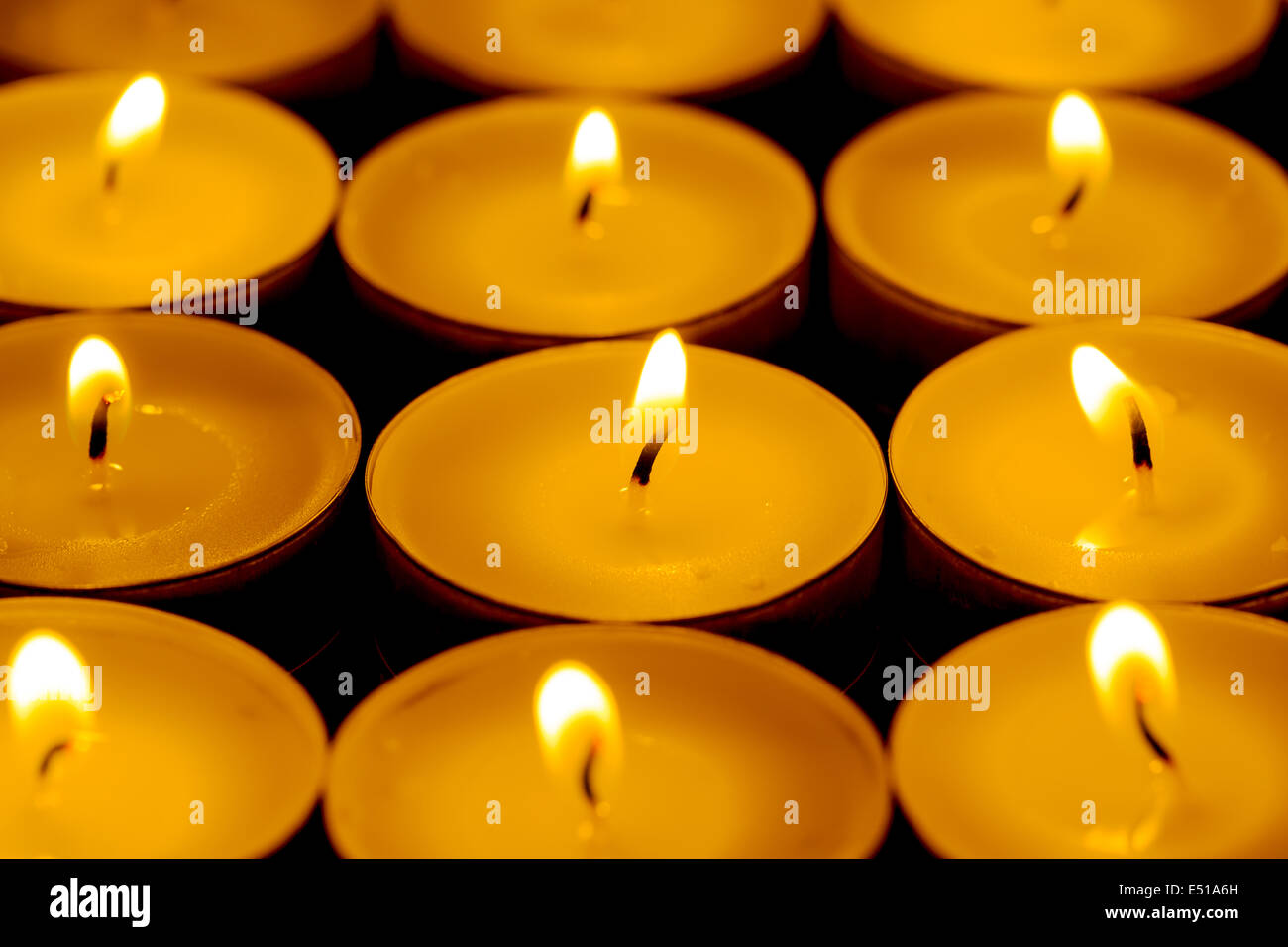 Tea lights candles with fire Stock Photo - Alamy