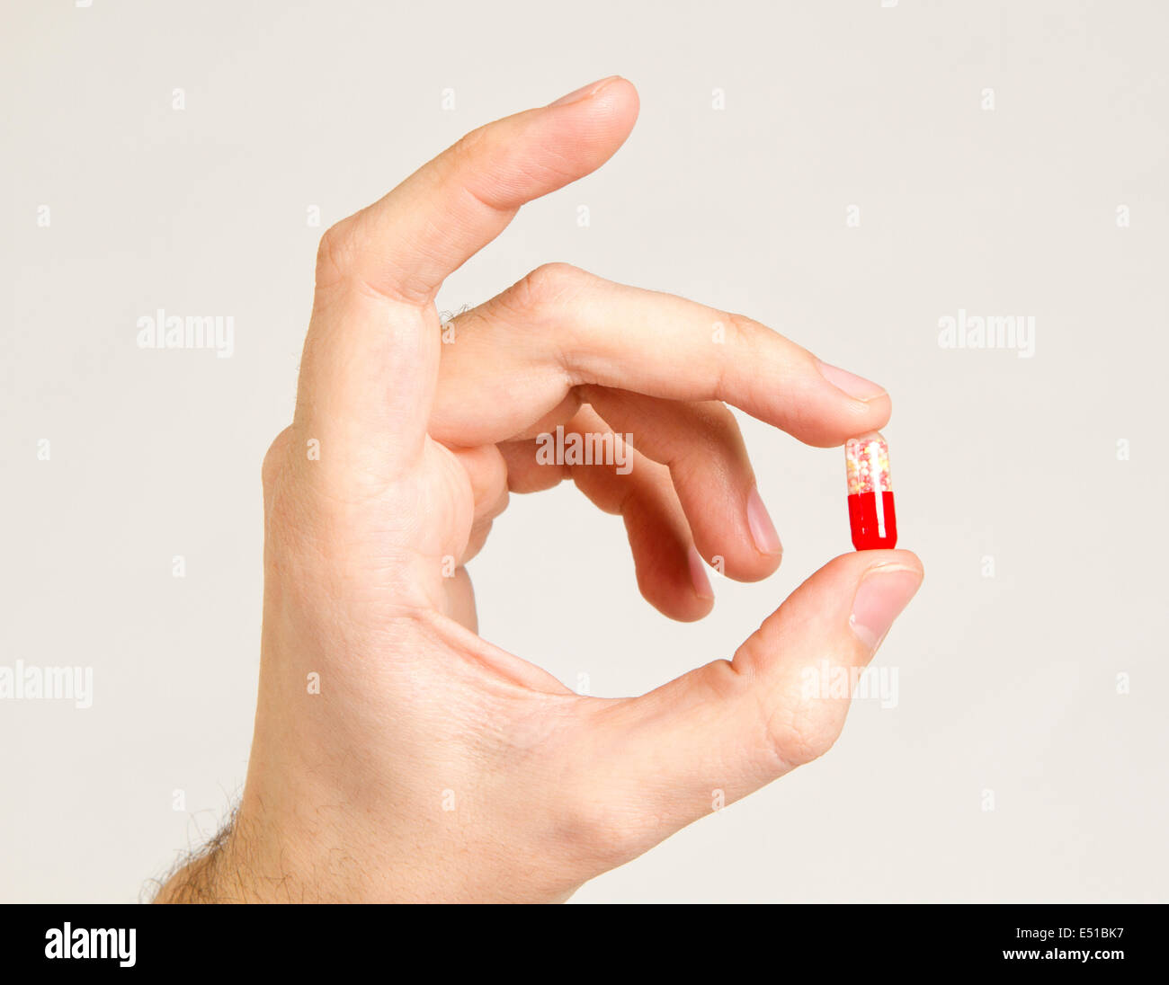 Hand and pill Stock Photo - Alamy