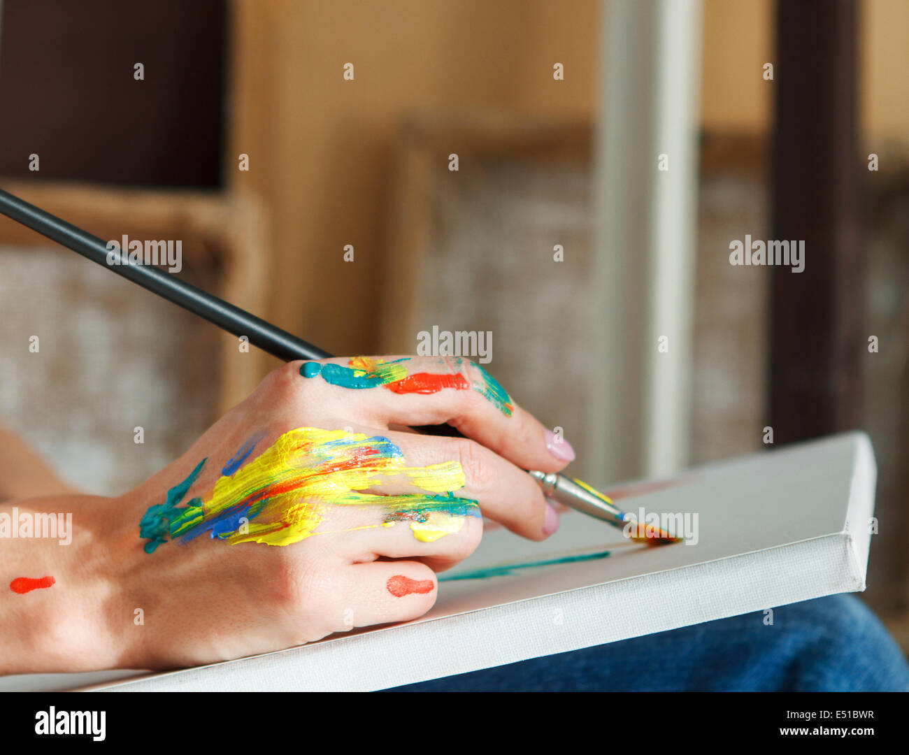 Female artist hand holding paintbrush Stock Photo - Alamy