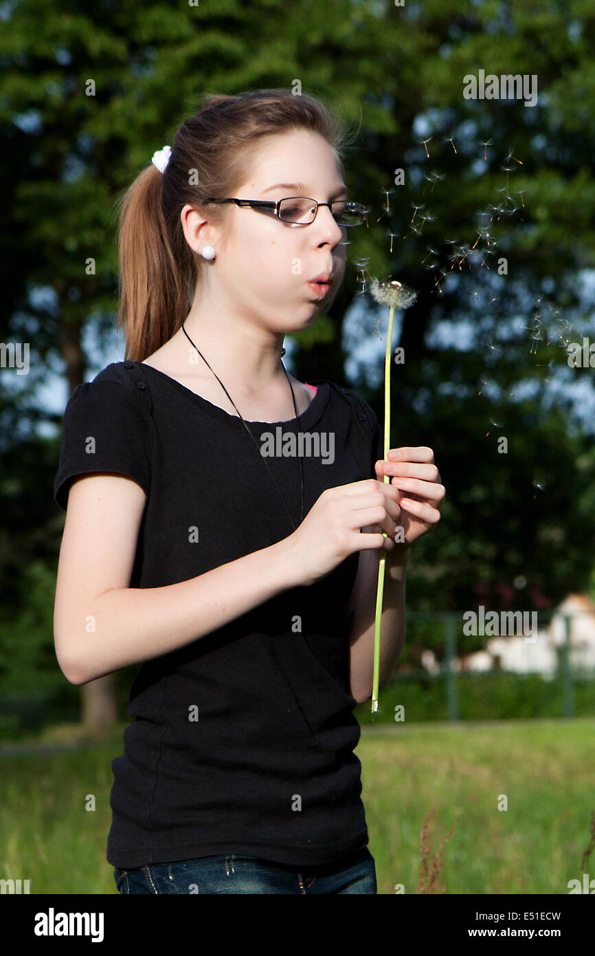 Blowing into dandelion Stock Photo - Alamy