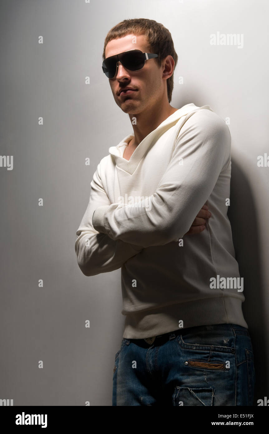 man standing near a wall Stock Photo - Alamy