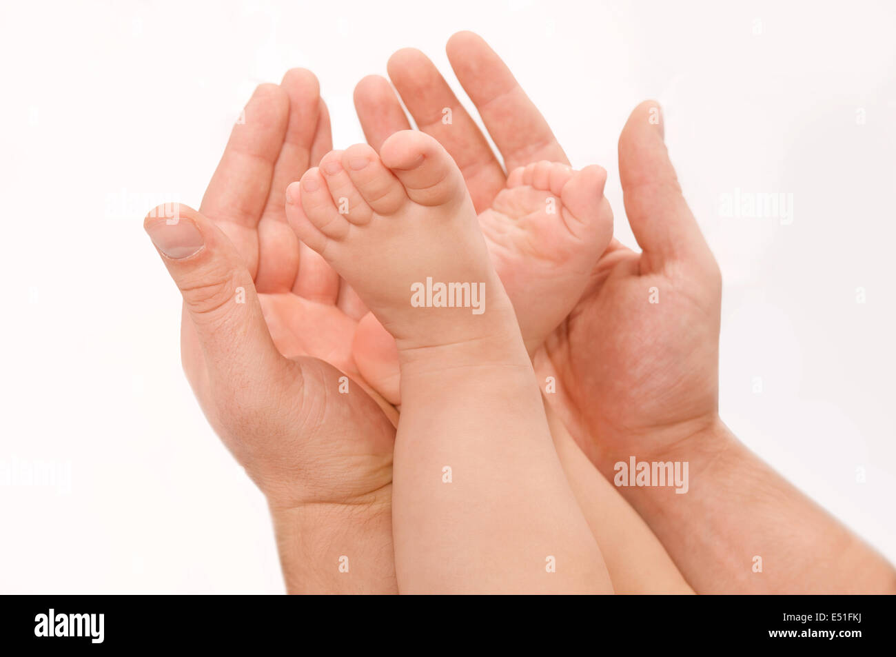 man's hand and children's foot Stock Photo - Alamy