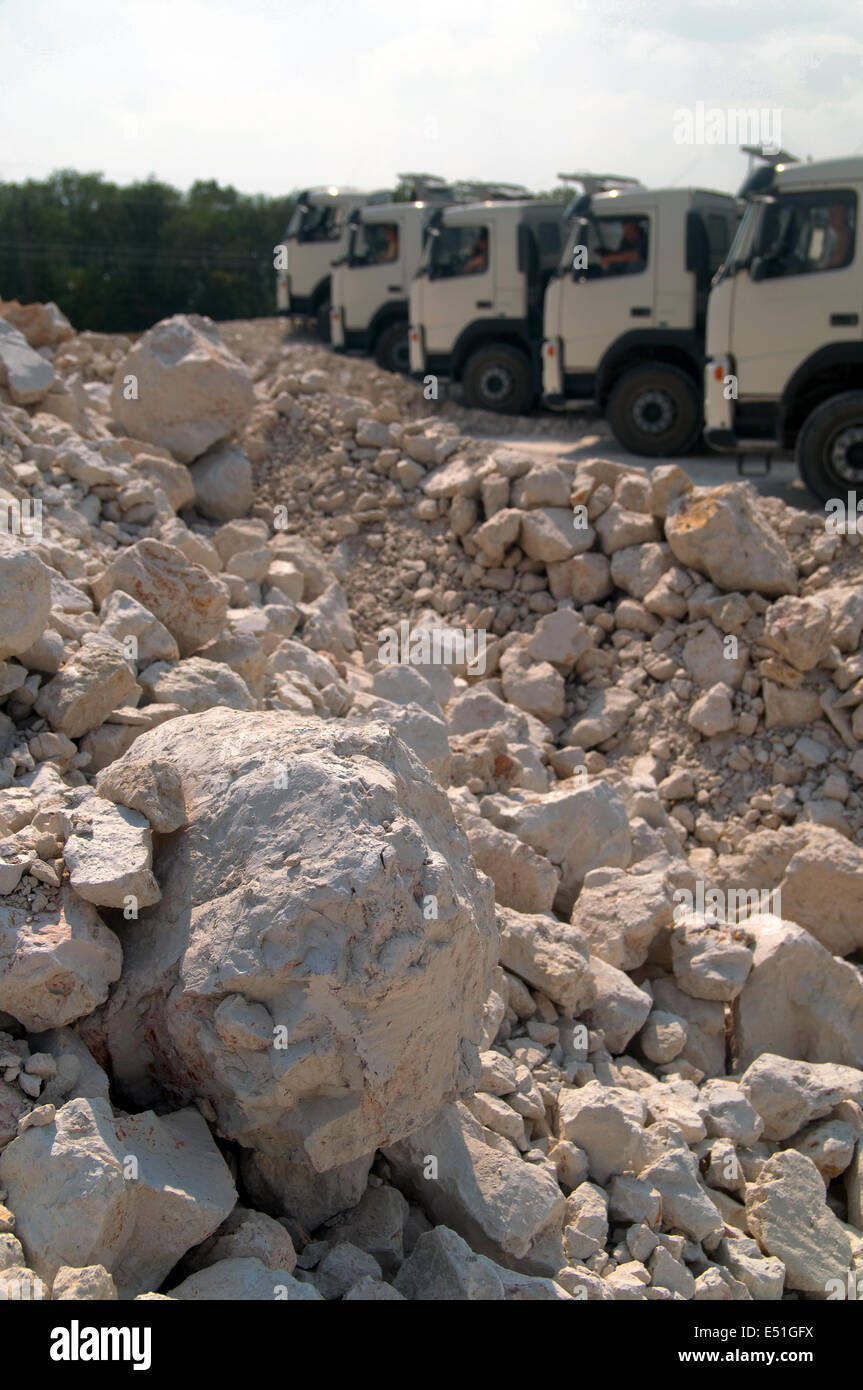 piles of gravel and trucks Stock Photo - Alamy