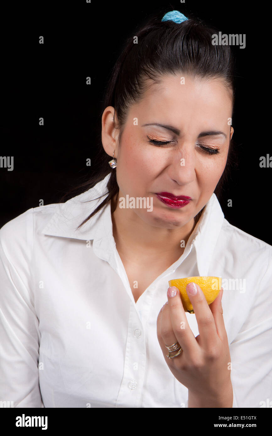 Young woman eating lemon grimace hi-res stock photography and images ...