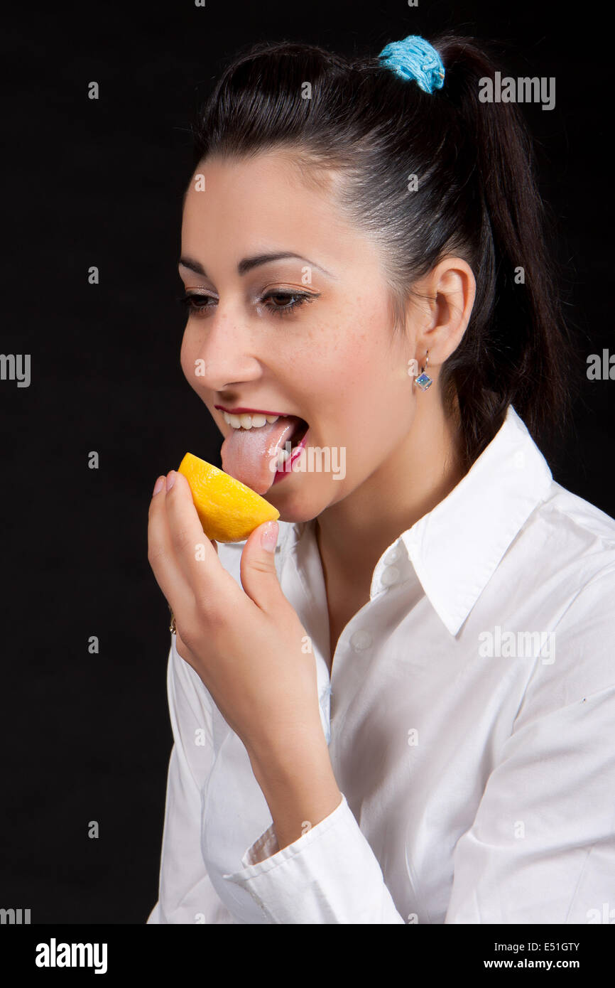 woman eat yellow lemon Stock Photo - Alamy