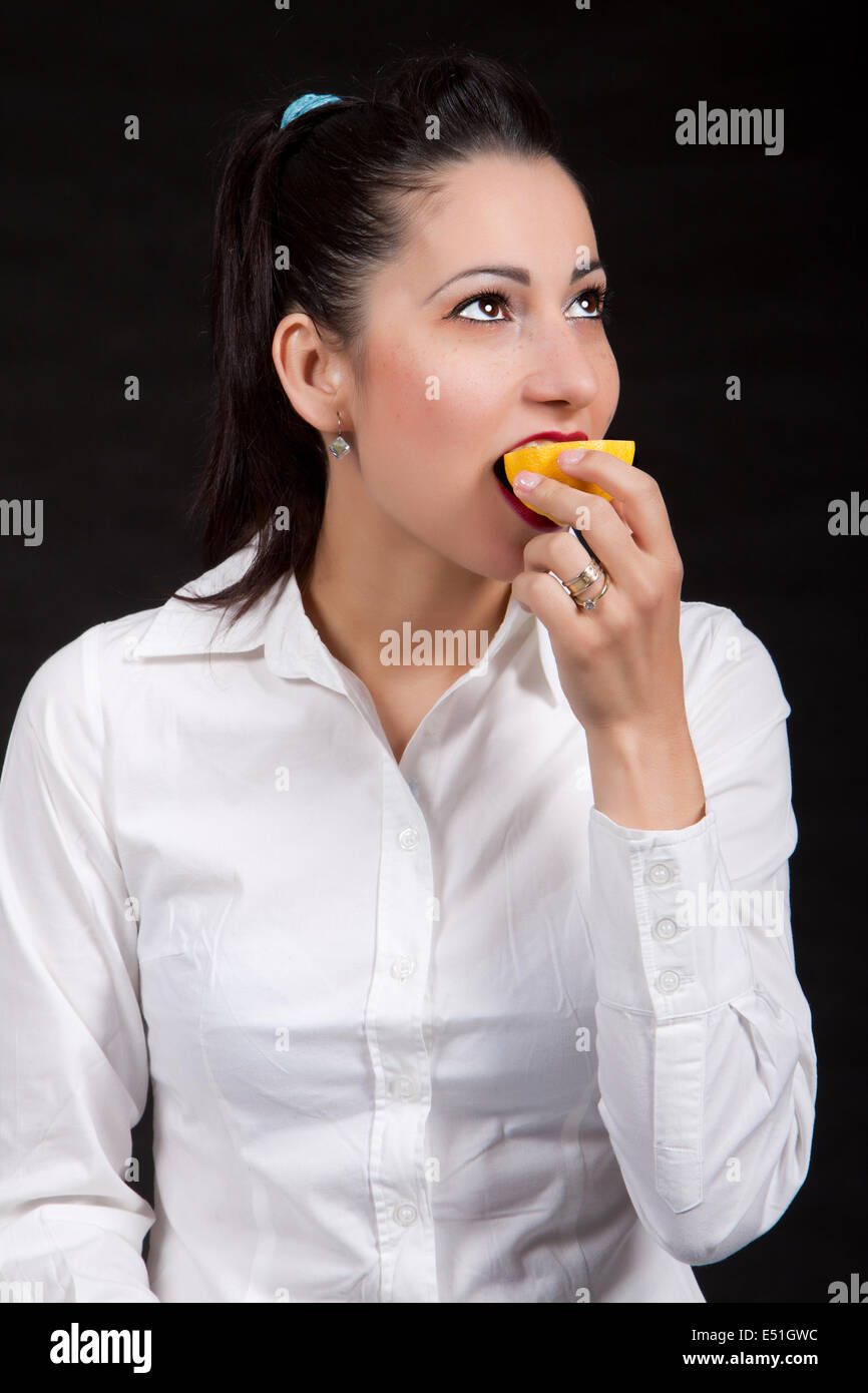 woman eat yellow lemon Stock Photo - Alamy