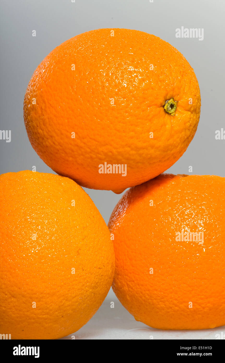 three oranges lying on the ground Stock Photo - Alamy