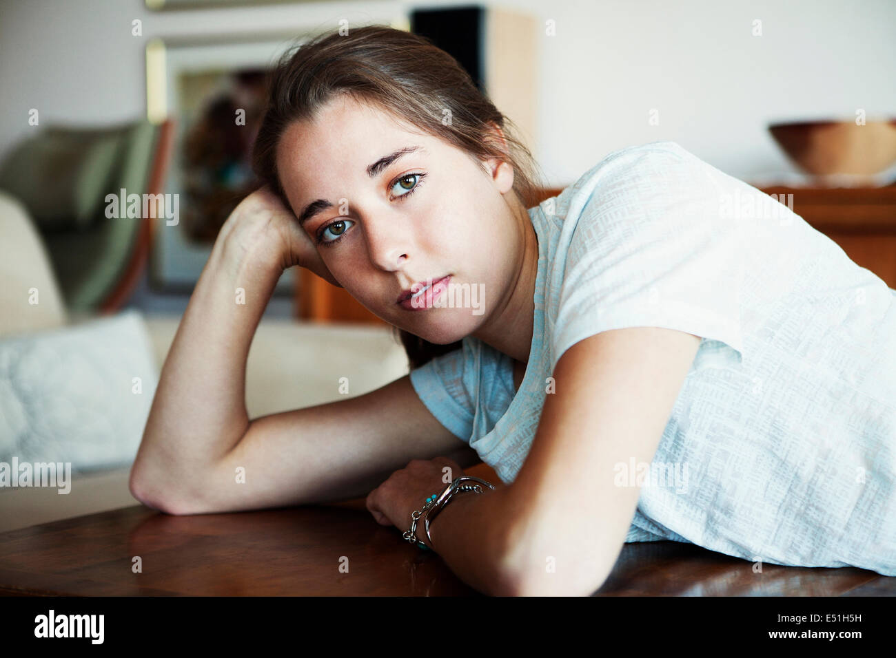 Young woman laying on table Stock Photo - Alamy