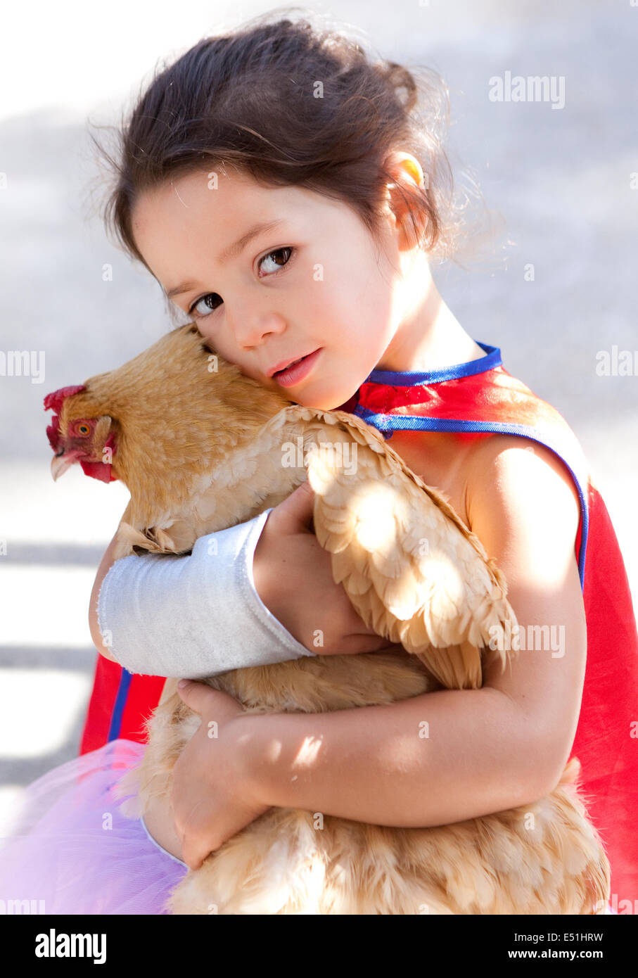 Girl (4-5) hugging chicken Stock Photo - Alamy