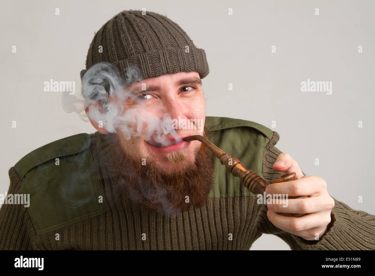 young bearded guy smoking a pipe Stock Photo - Alamy