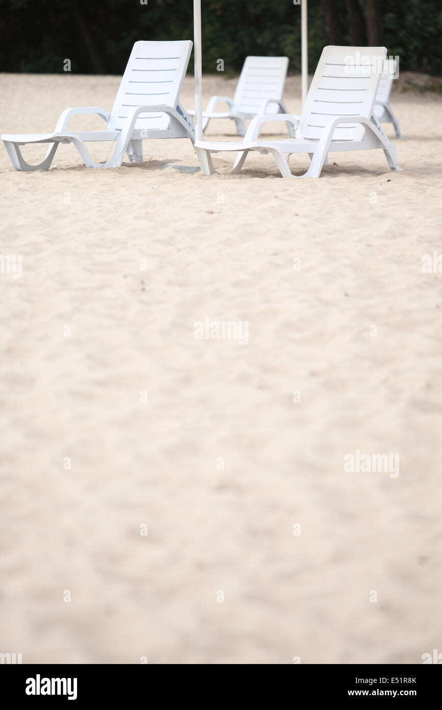 white pool chairs on sand beach Stock Photo - Alamy