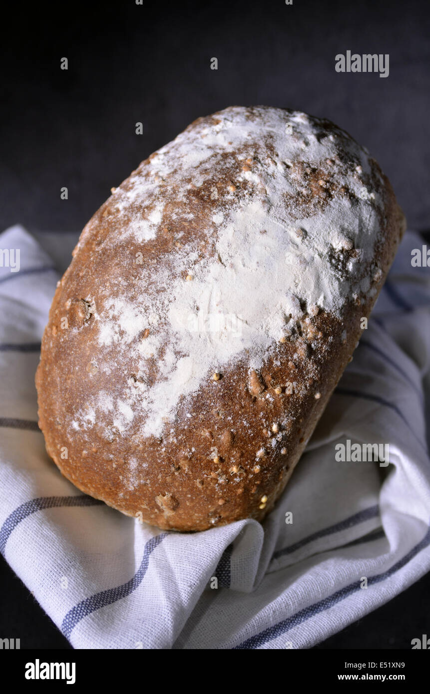 Flour dusted multi grain loaf of bread Stock Photo - Alamy