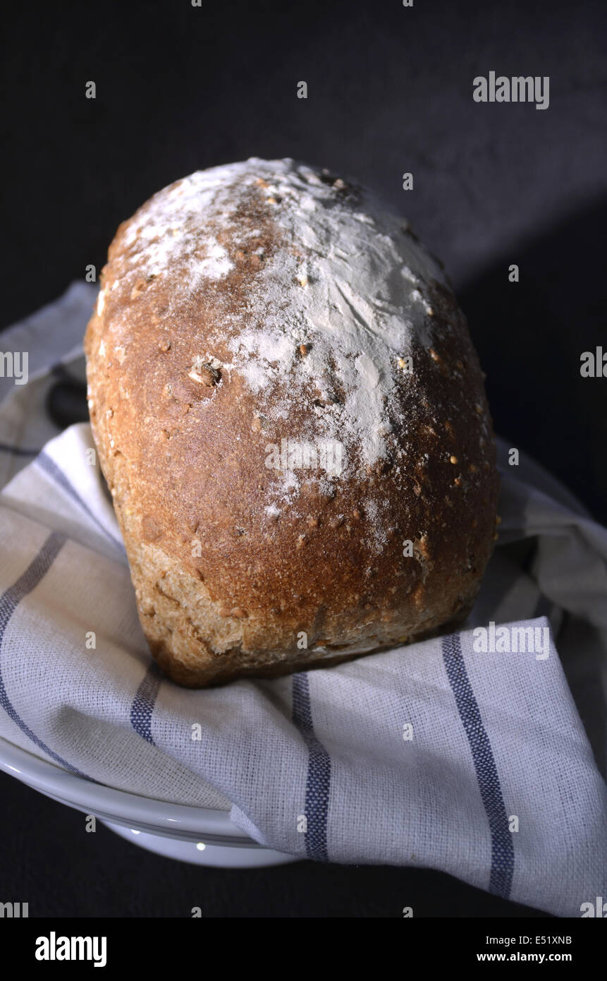 Flour dusted multi grain loaf of bread Stock Photo - Alamy