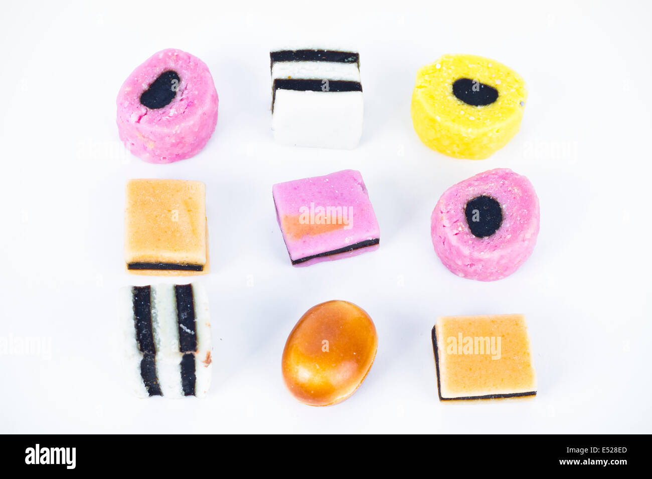 Candies in a row on white background Stock Photo - Alamy