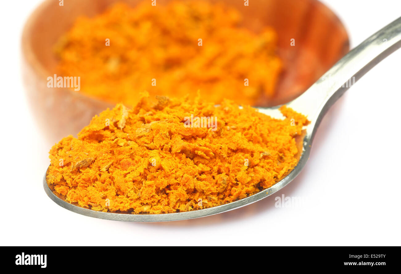 Grated turmeric over white background Stock Photo - Alamy
