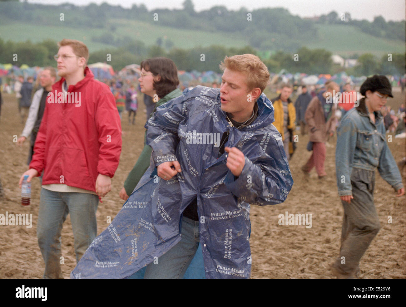Man dancing in the mud and rain, Glastonbury Festival 1997, Somerset ...