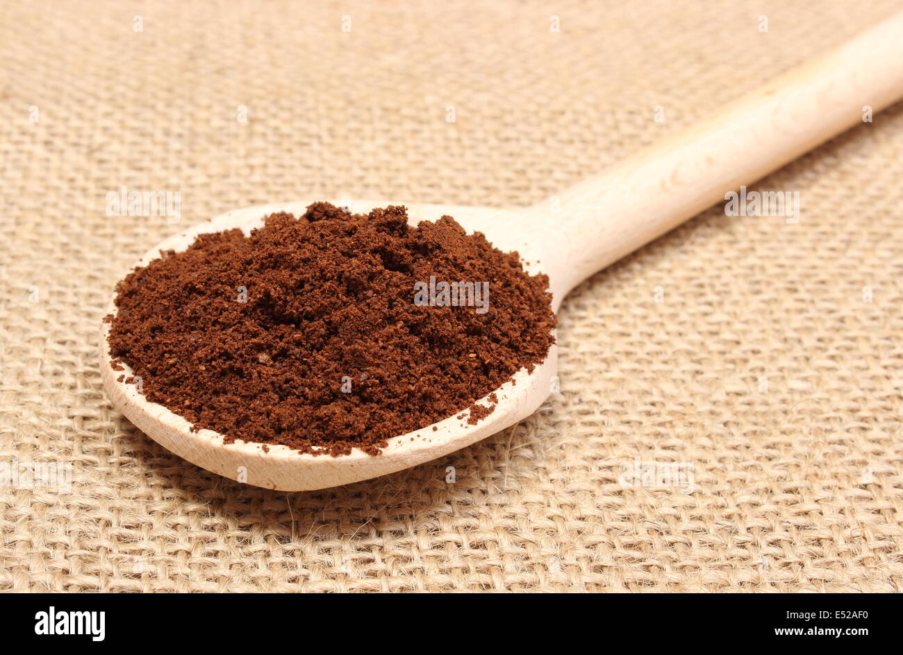Heap of ground coffee on wooden scoop, coffee grains. Background ...