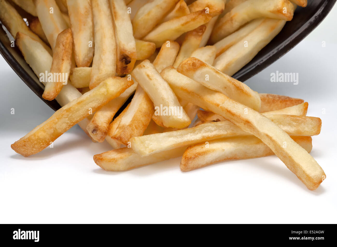 French fries in fryer on white background Stock Photo - Alamy