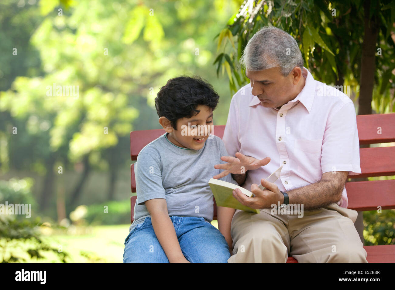 Grandfather and grandson with a book Stock Photo - Alamy