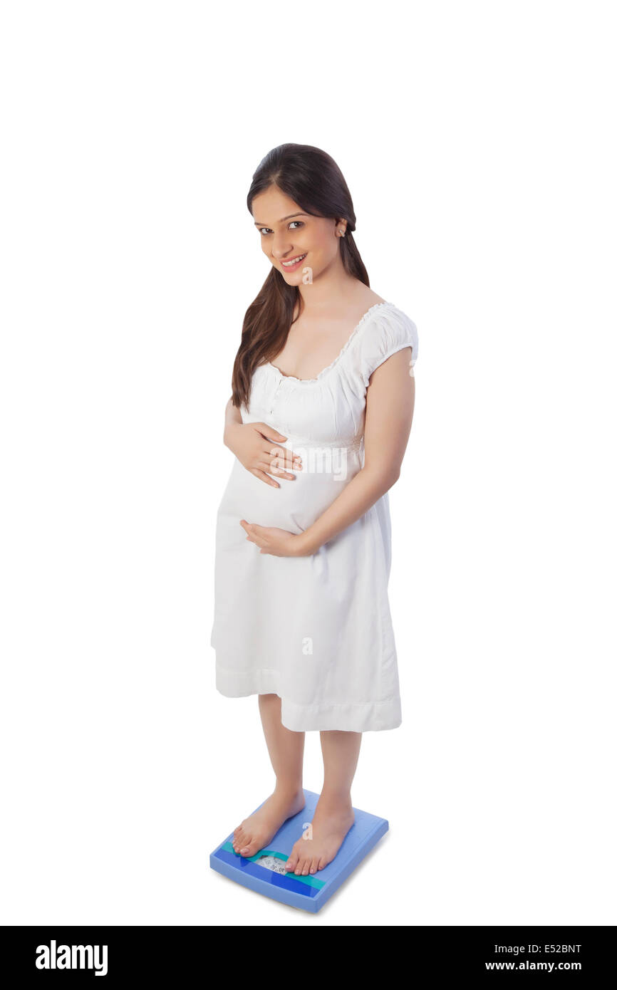 Pregnant woman checking her weight Stock Photo - Alamy