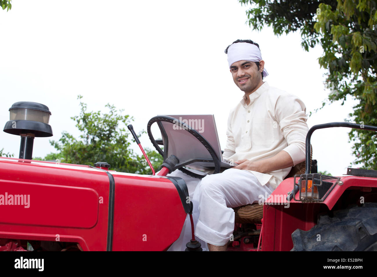 Farmer sitting on a tractor hi-res stock photography and images - Alamy