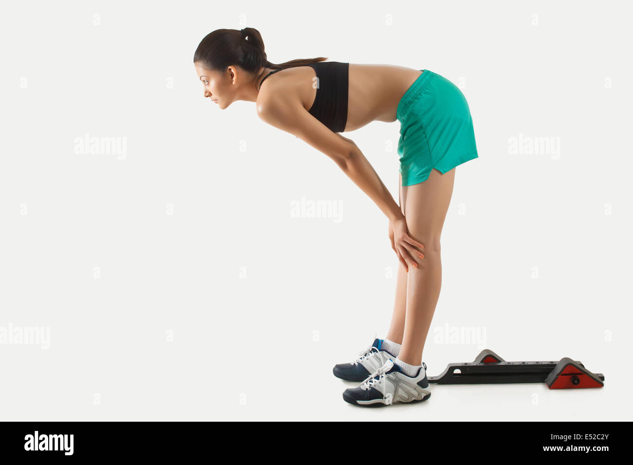 Side view of young sporty woman at starting block of race isolated over ...
