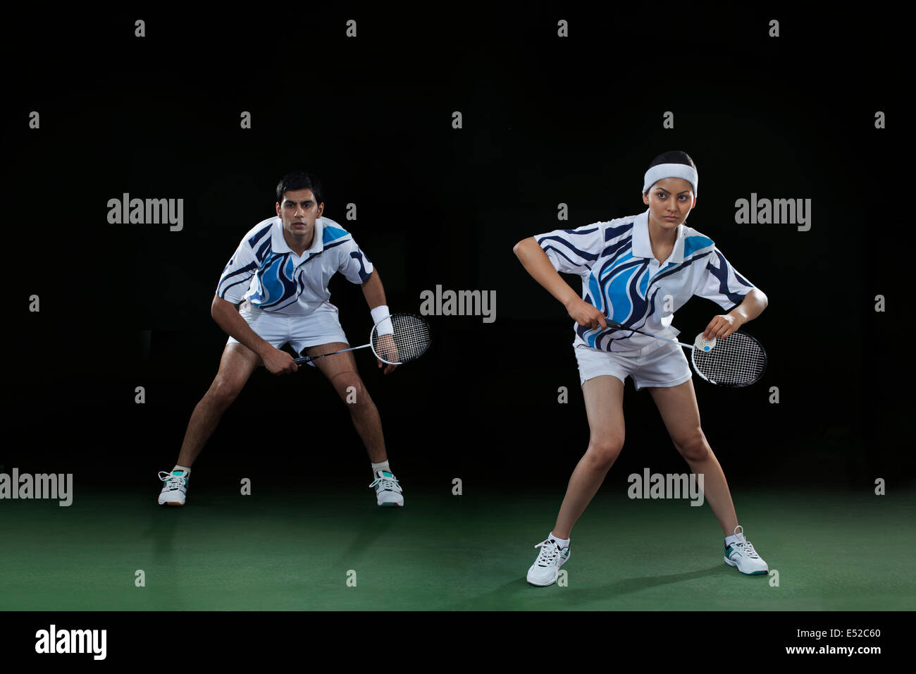 Man and woman playing badminton doubles Stock Photo - Alamy