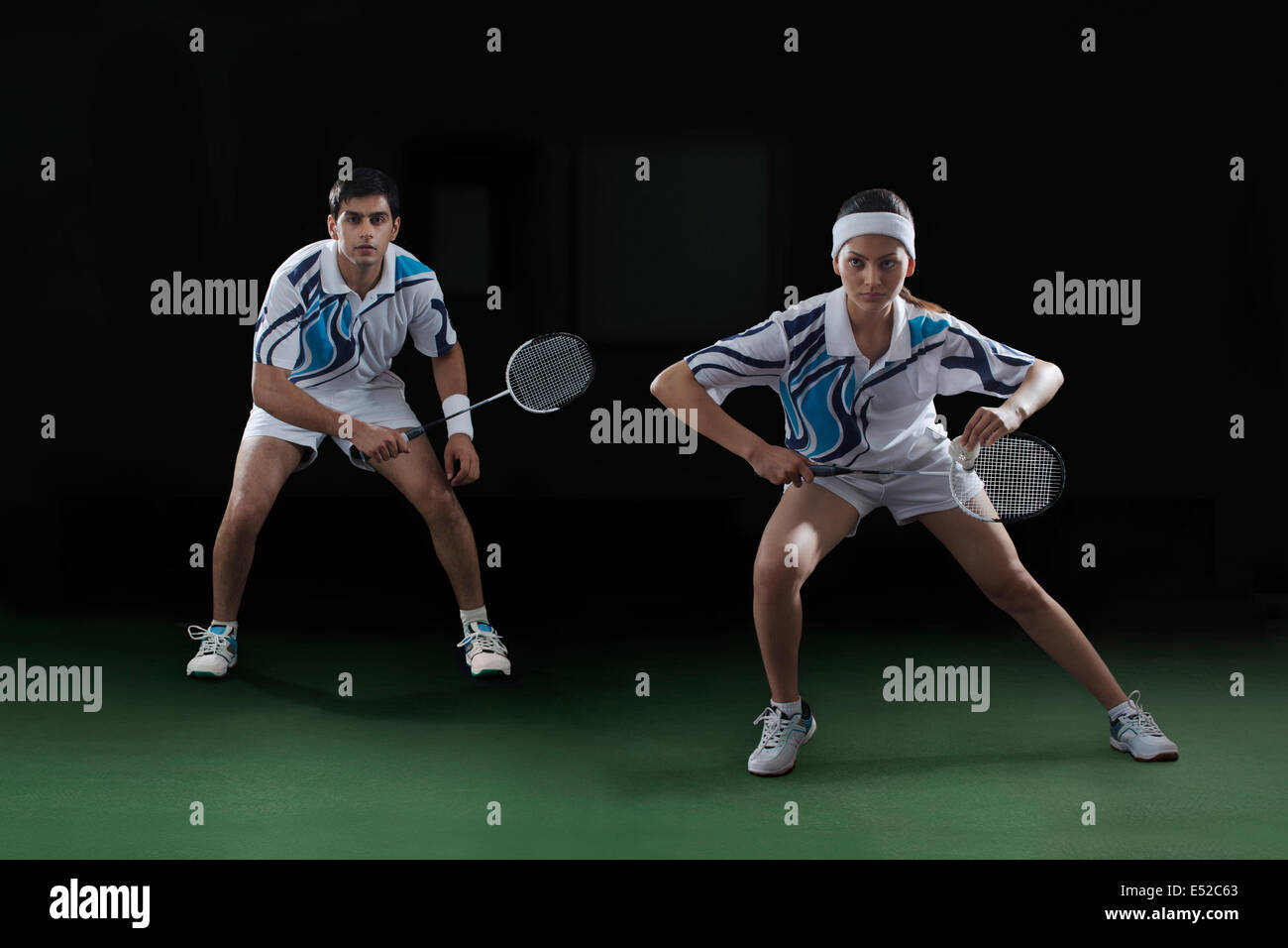 Man and woman playing badminton doubles at court Stock Photo - Alamy